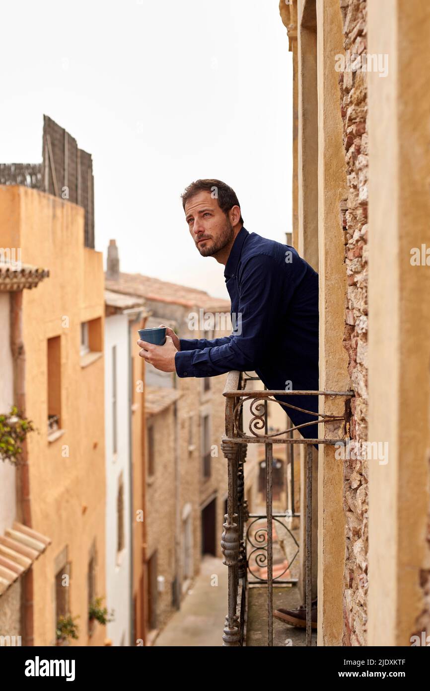 Man leaning on balcony hi-res stock photography and images - Alamy