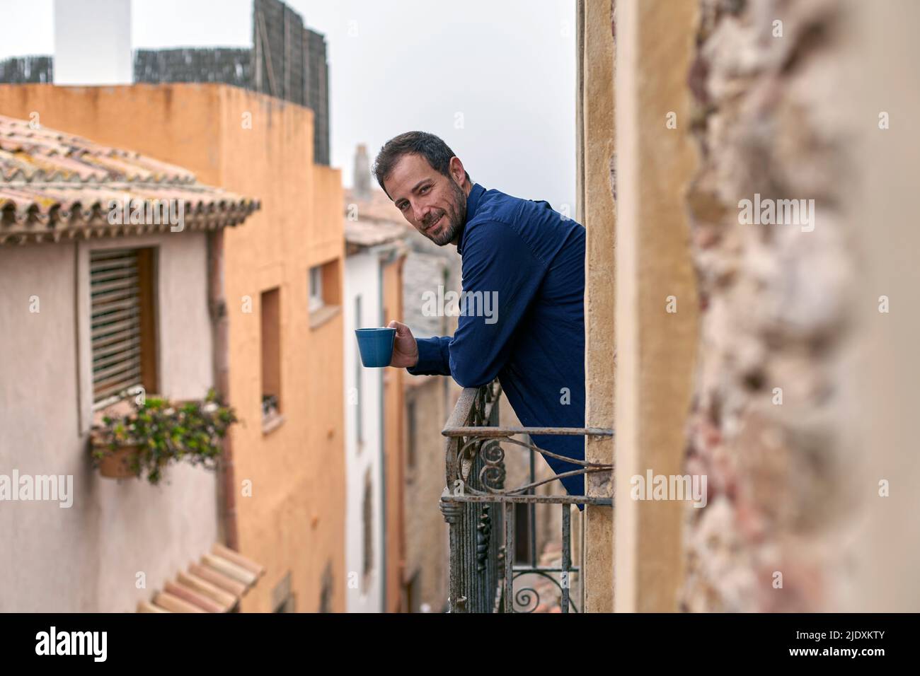 Man leaning on balcony hi-res stock photography and images - Alamy