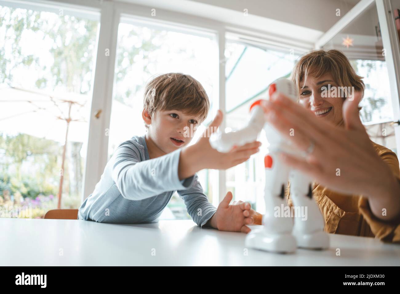 Mother and son playing with toy robot at home Stock Photo - Alamy