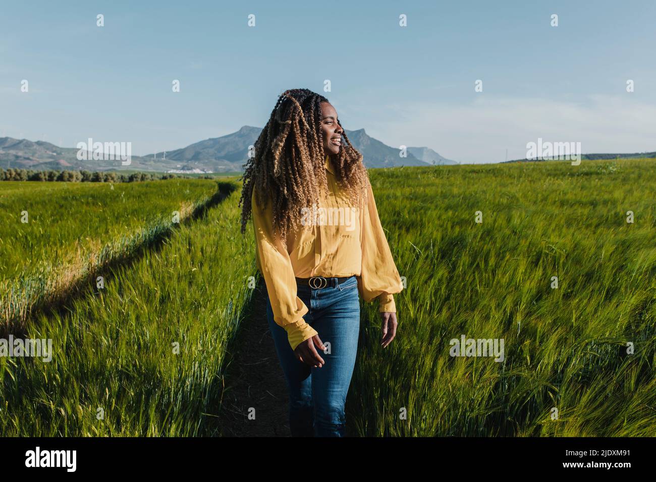Young woman walking in meadow hi-res stock photography and images - Alamy