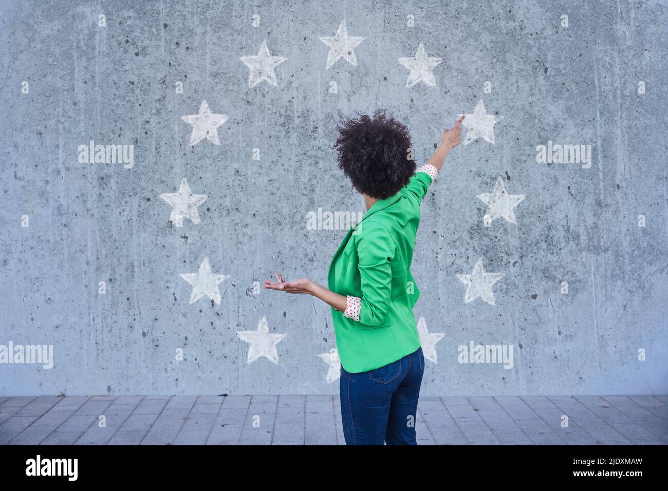 Woman pointing at European stars painted on wall Stock Photo - Alamy
