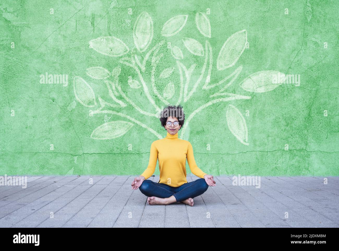 Woman meditating under tree hi-res stock photography and images - Alamy