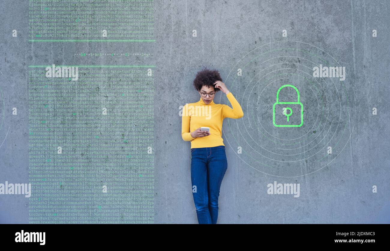 Confused woman looking at smartphone with data lock painted on wall ...