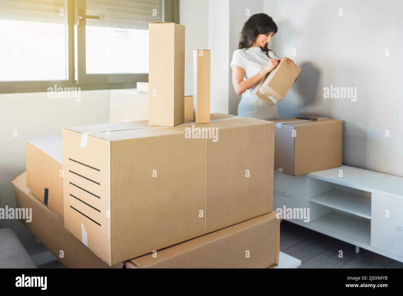 Woman unpacking boxes hi-res stock photography and images - Alamy