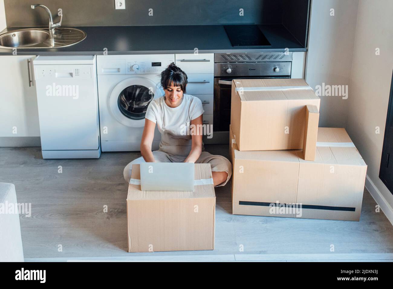 Woman using washing machine hi-res stock photography and images - Alamy