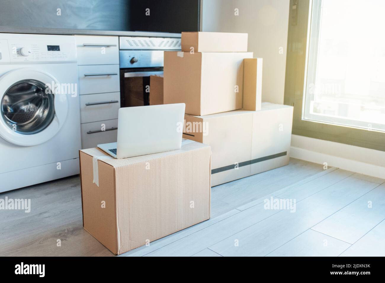 Laptop on cardboard box in utility room Stock Photo - Alamy