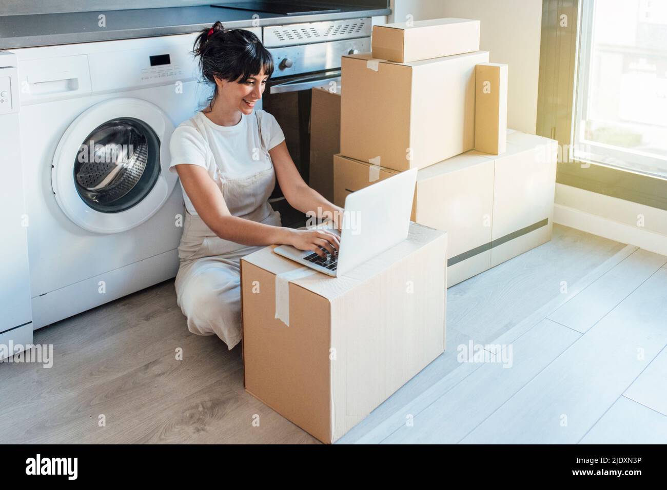 Woman sitting on washing machine hi-res stock photography and images ...