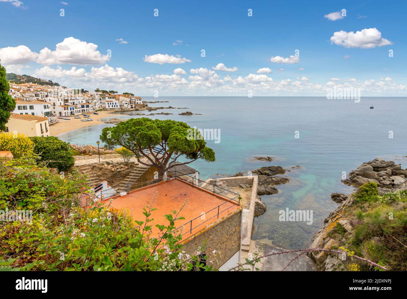 The rocky coast, sandy beach and whitewashed fishing village of Calella ...