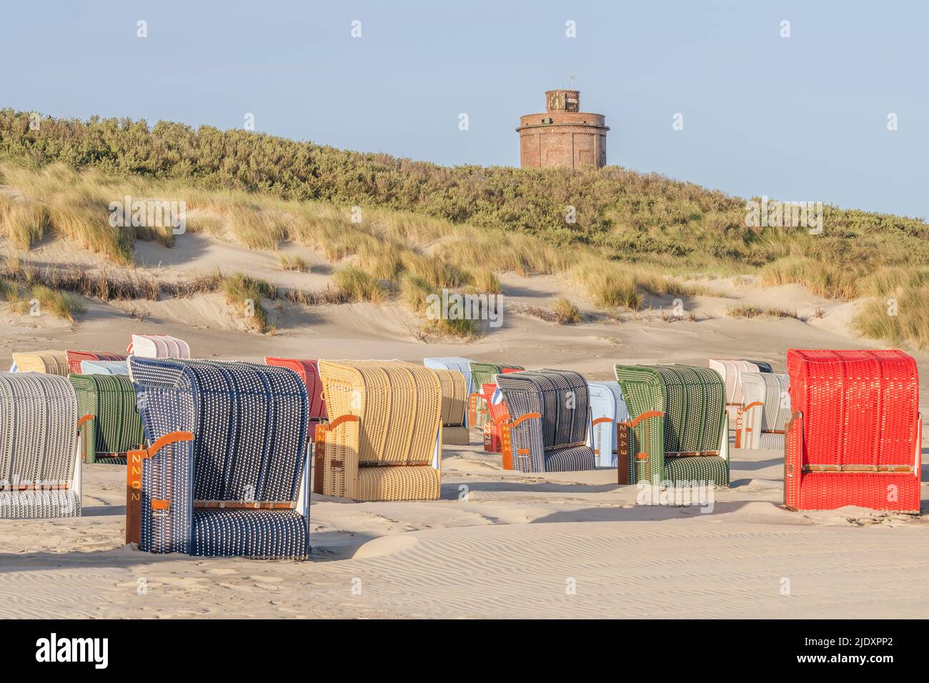 Germany, Lower Saxony, Juist, Hooded beach chairs on empty beach with ...