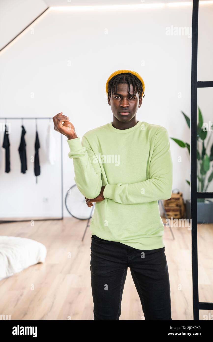Confident young man standing home hi-res stock photography and images ...