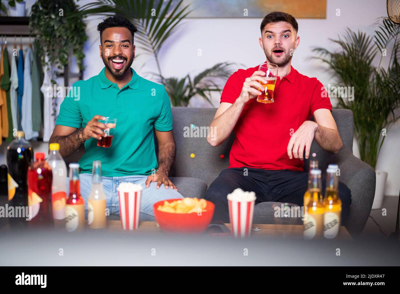 Watching football on sofa hi-res stock photography and images - Alamy