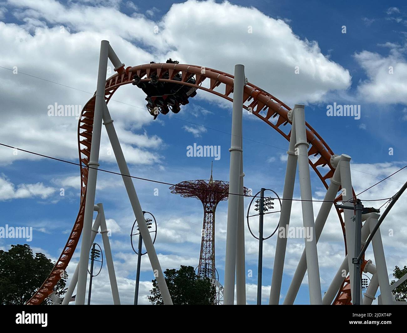 People ride the fast moving Thunderbolt roller coaster at Coney Island ...