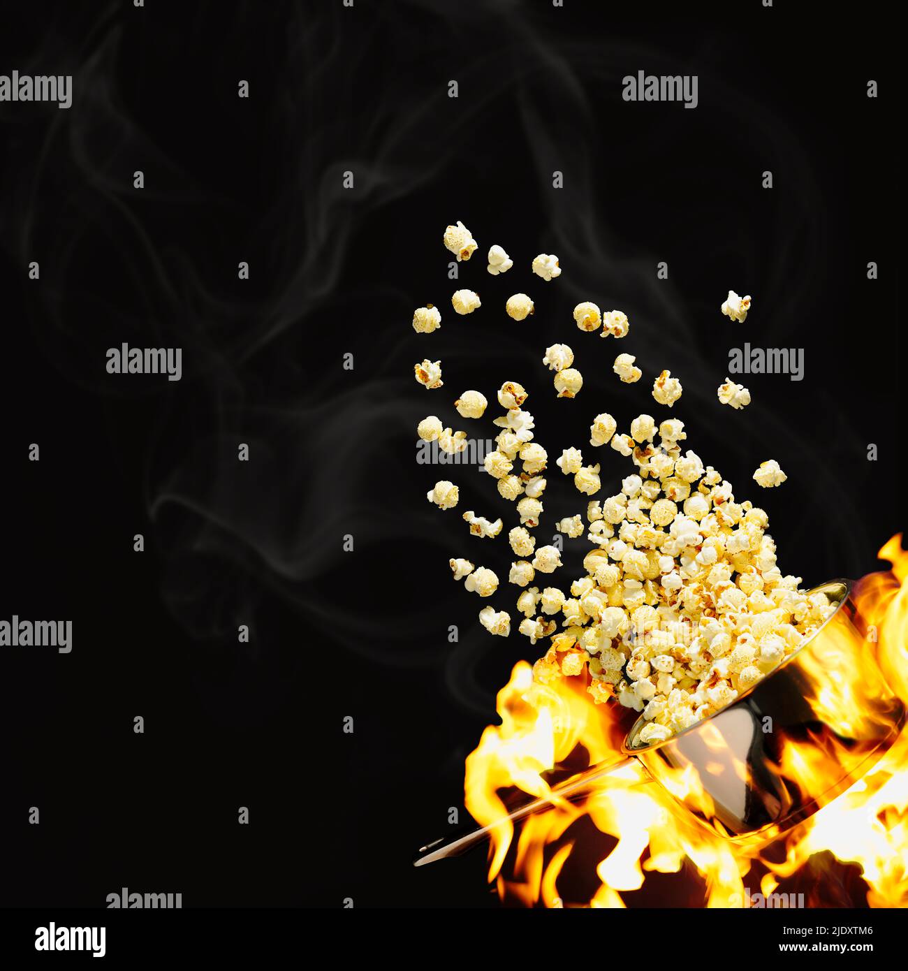 Flying popcorn on a dark background. Hot popcorn flying from pot under ...