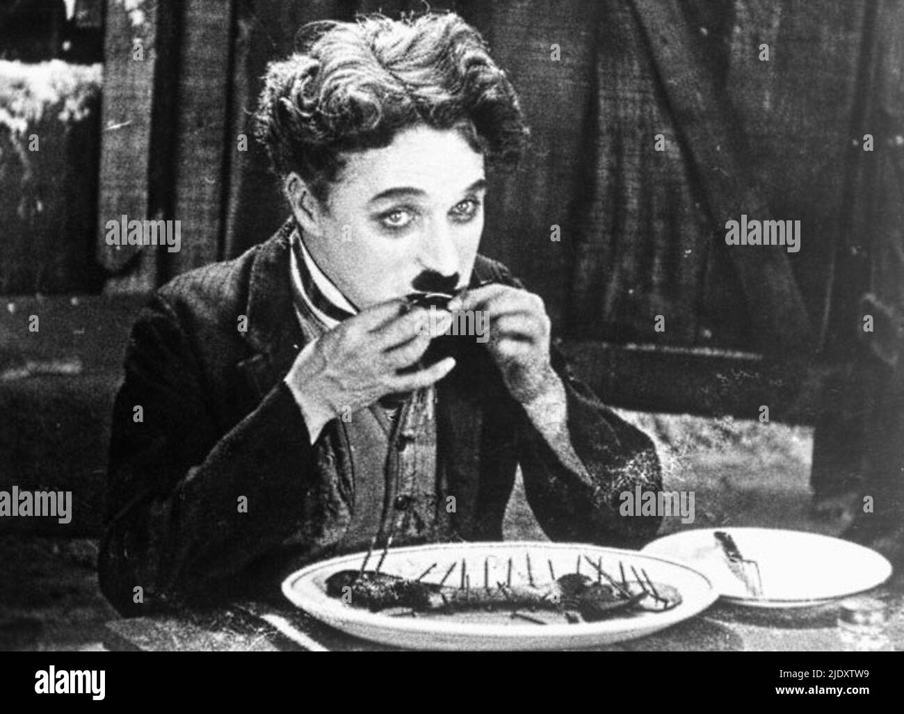 Charlie Chaplin as The Tramp resorts to eating his boot in the 1925 ...