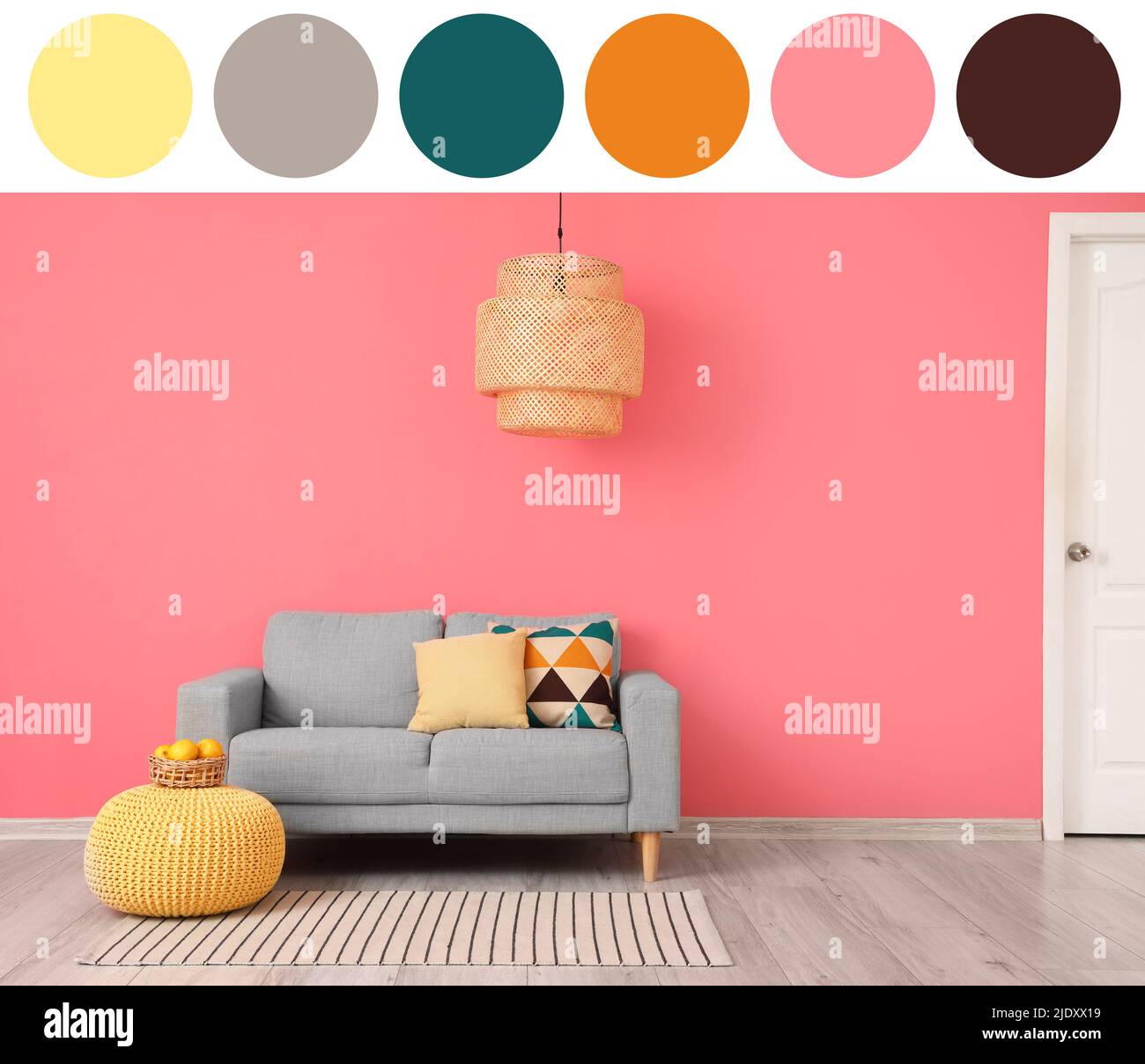 Comfortable sofa and pouf near pink wall. Different color patterns ...