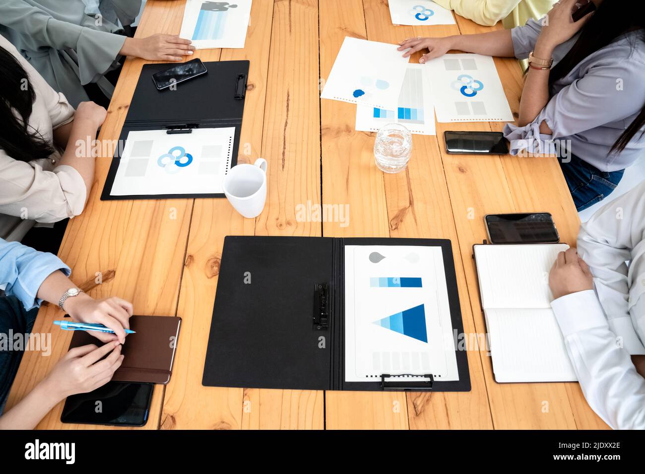 Employees Meeting in conference room. There are triangular diagrams ...