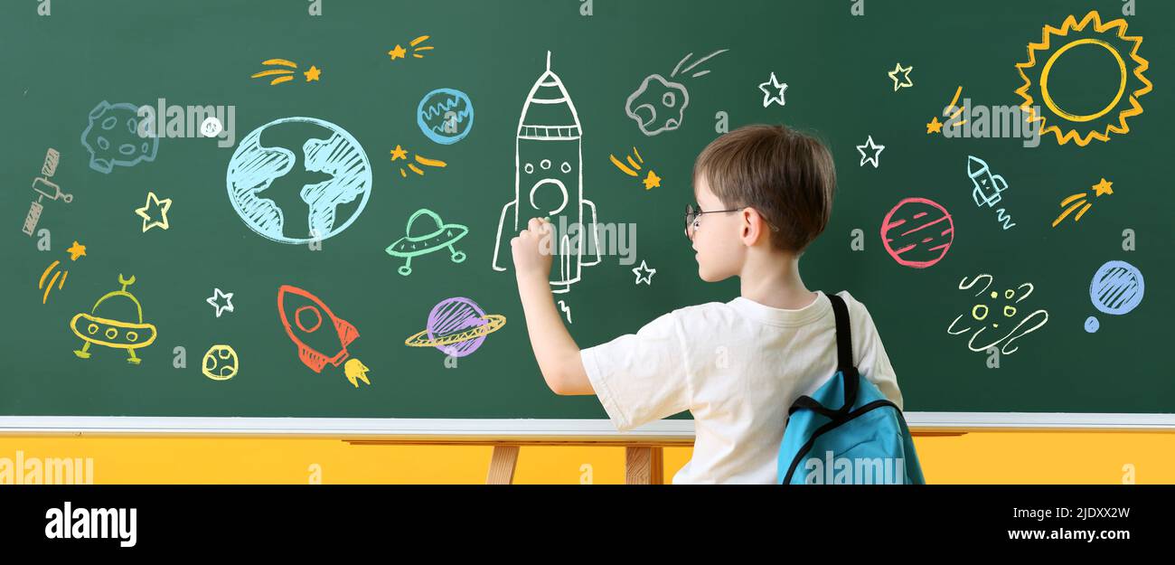 Little boy drawing space on school blackboard Stock Photo - Alamy