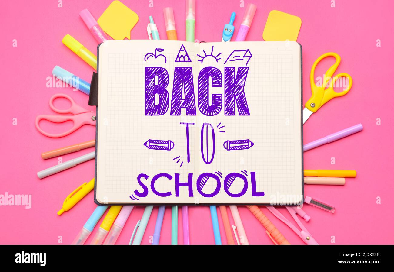 Notebook with text BACK TO SCHOOL and stationery on pink background ...