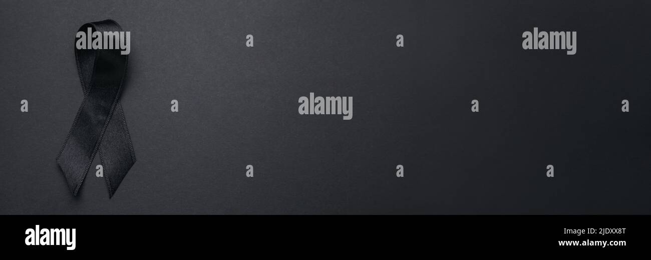 Black funeral ribbon on dark background with space for text Stock Photo ...