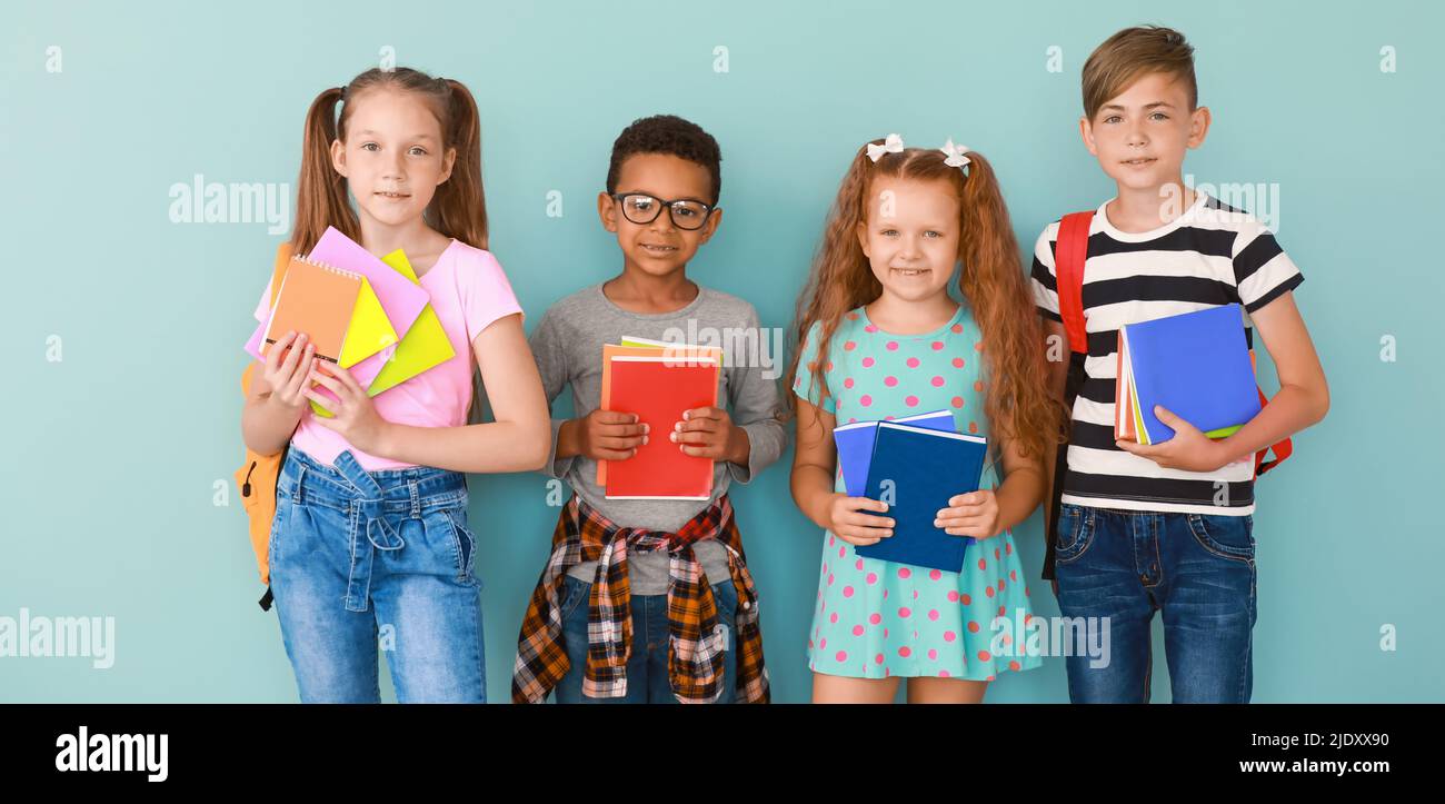 Cute little students on light blue background Stock Photo - Alamy