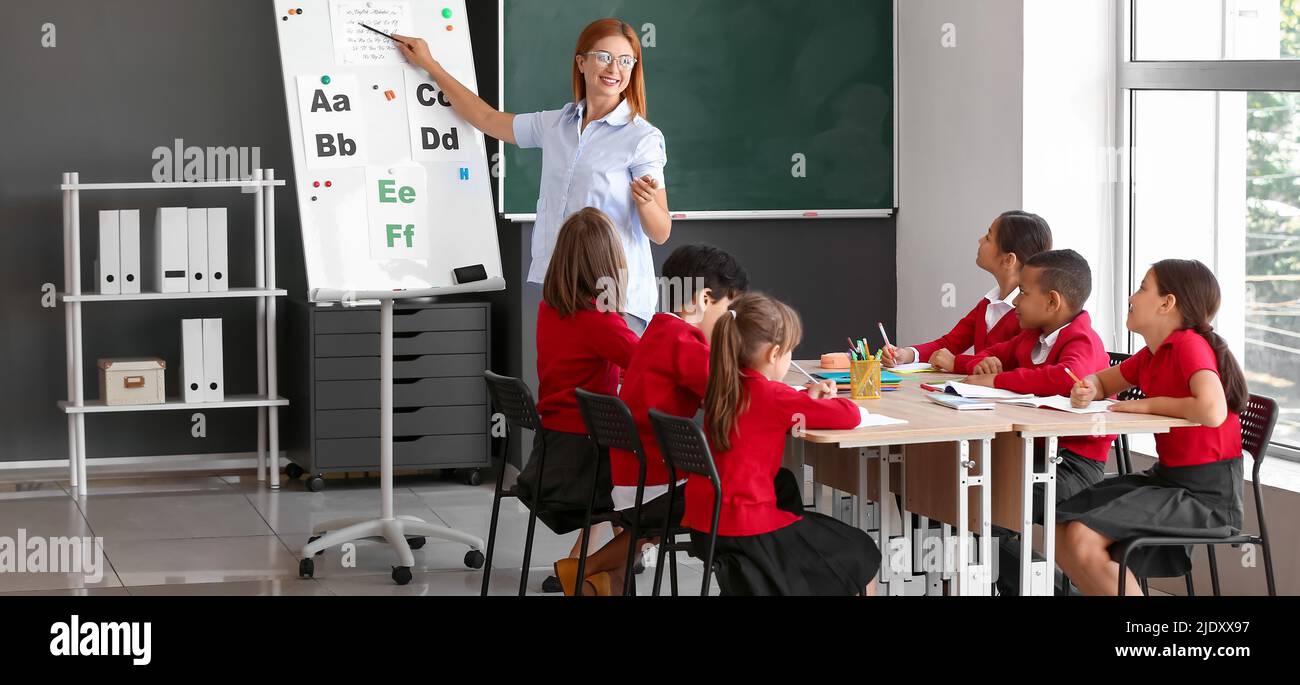 Teacher conducting lesson in classroom Stock Photo - Alamy