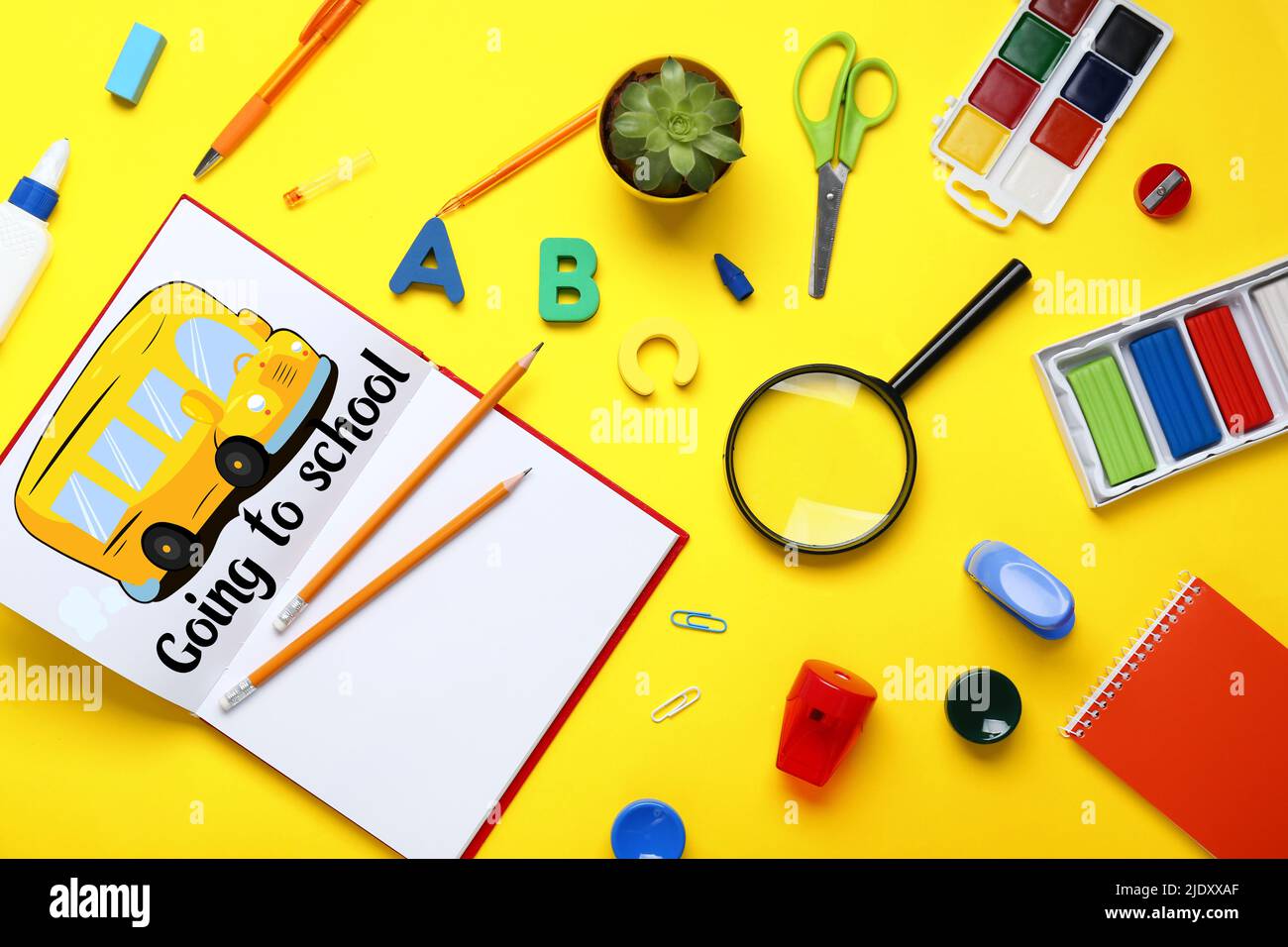 Set of stationery, notebook with drawn bus and text GOING TO SCHOOL on ...
