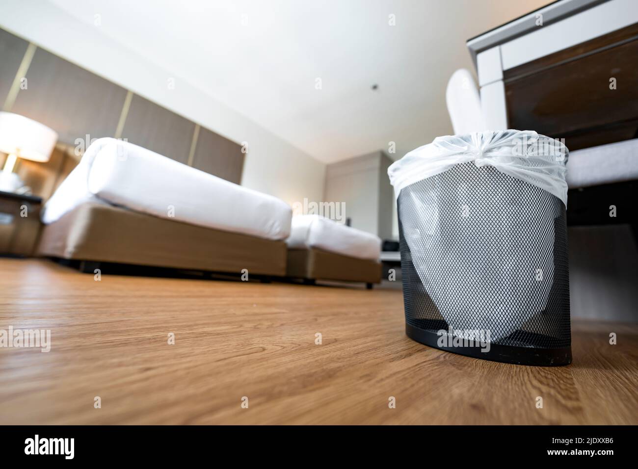 A container trash in the room with plastic inside it in hotel and ...