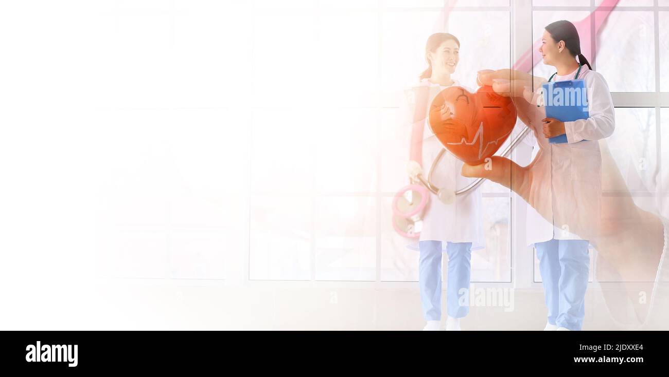 Double exposure of cardiologist with red heart and female doctors in ...