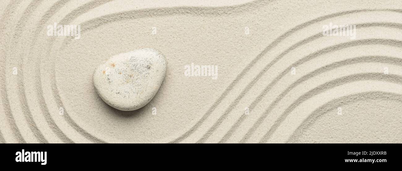 Stone on sand with lines, top view. Zen concept Stock Photo - Alamy