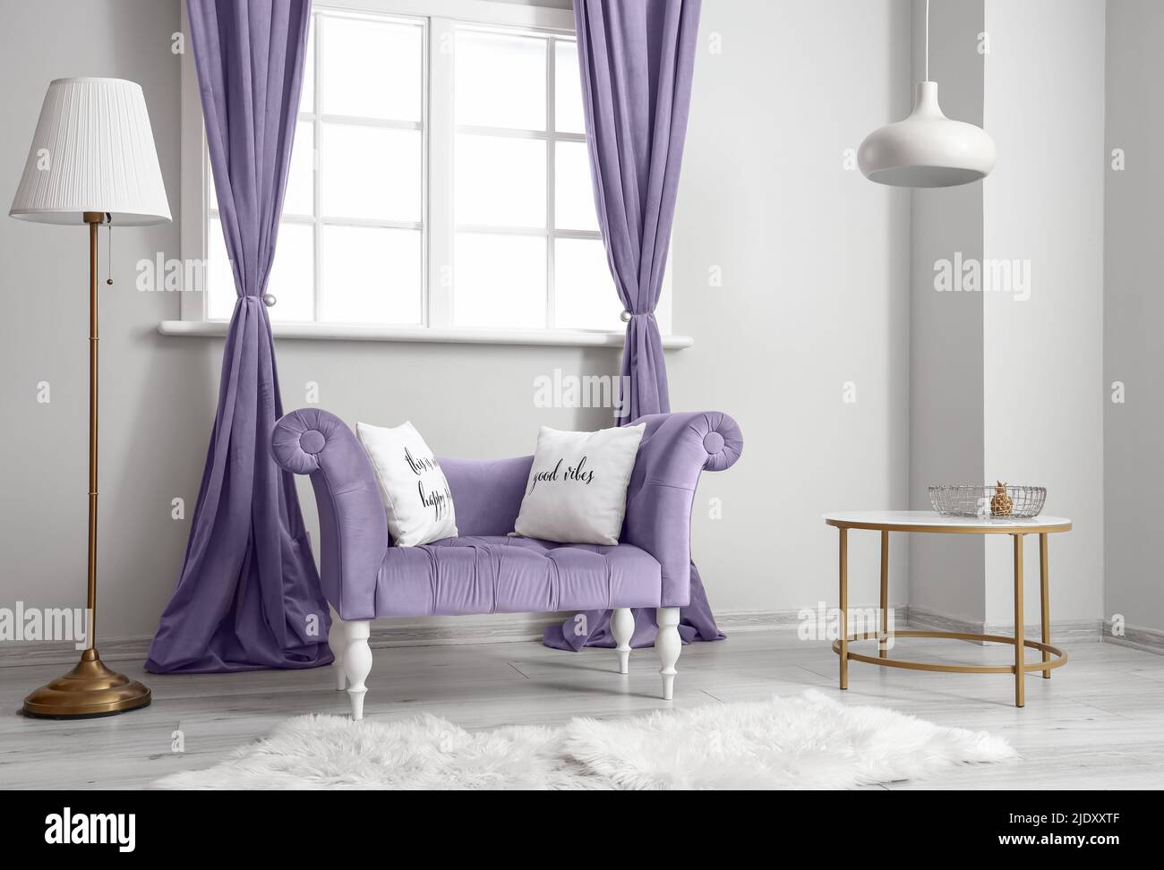 Interior of light room with purple armchair and curtains Stock Photo ...