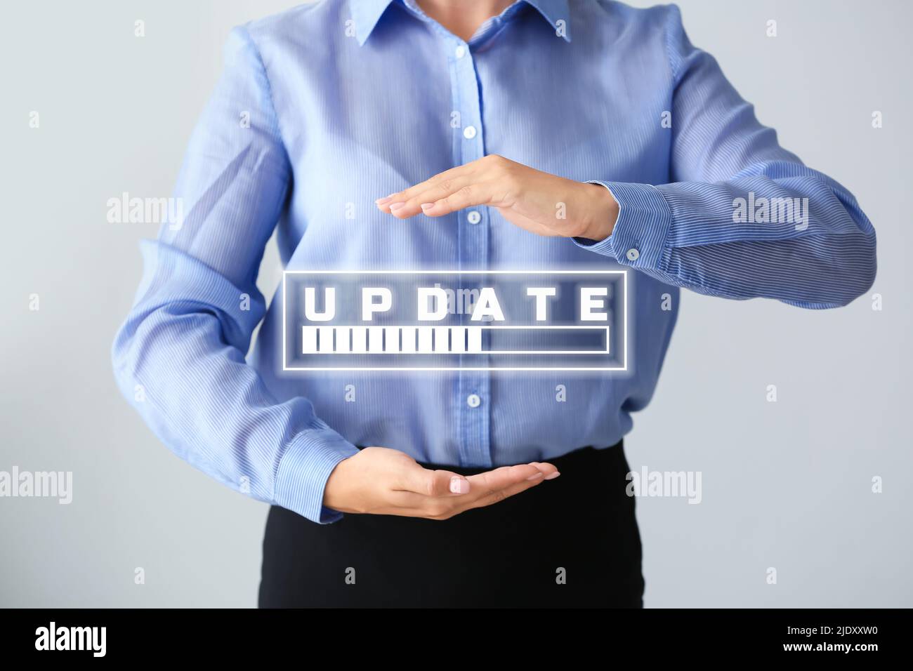 Businessman using virtual screen with word UPDATE and status bar on ...