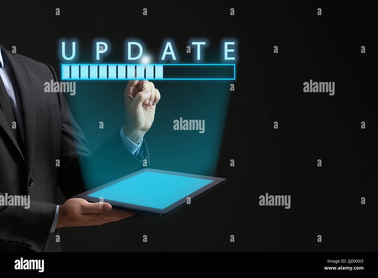 Businessman with tablet computer using virtual screen with word UPDATE ...