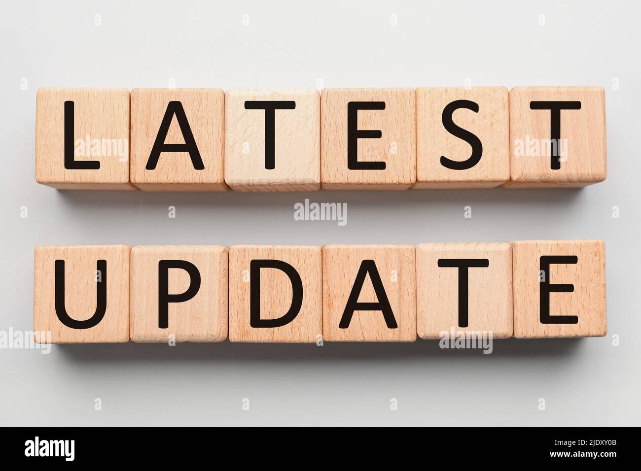 Text LATEST UPDATE made of wooden cubes on light background Stock Photo ...