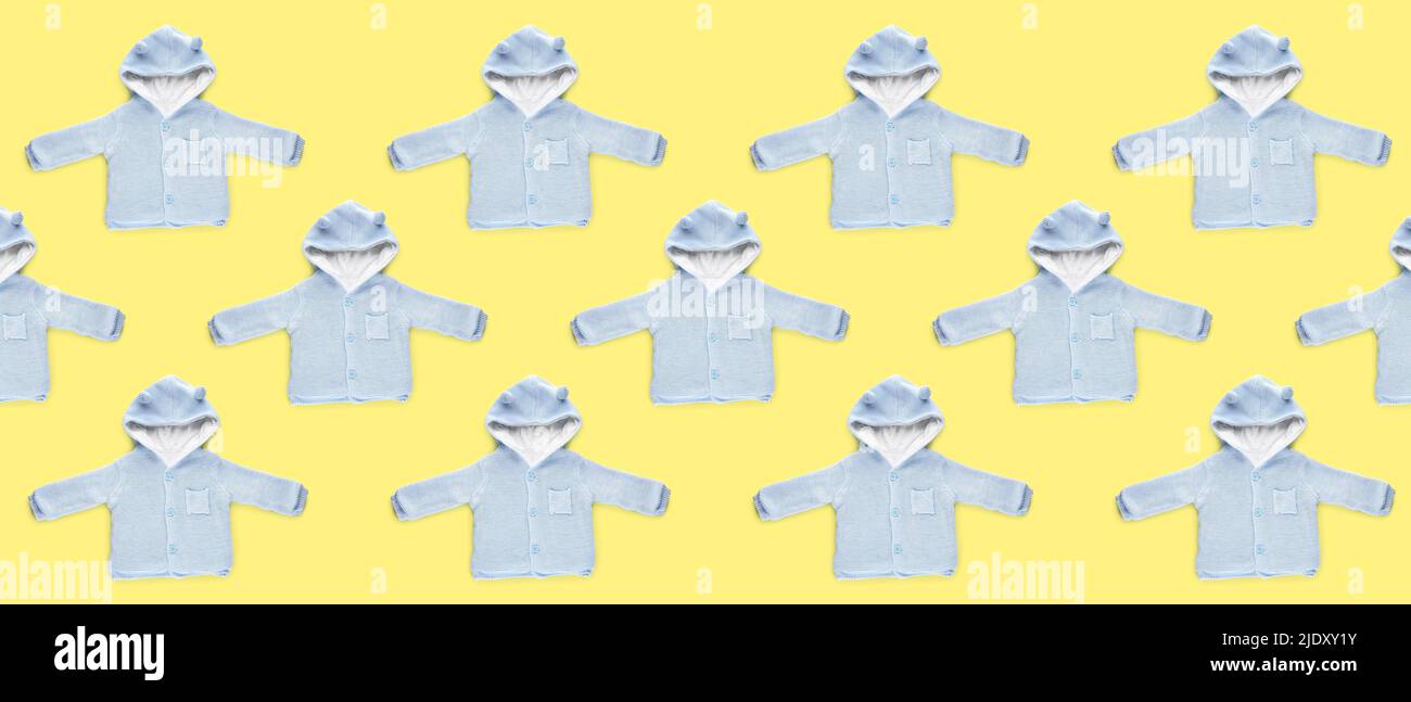 Many baby clothes on yellow background. Pattern for design Stock Photo ...
