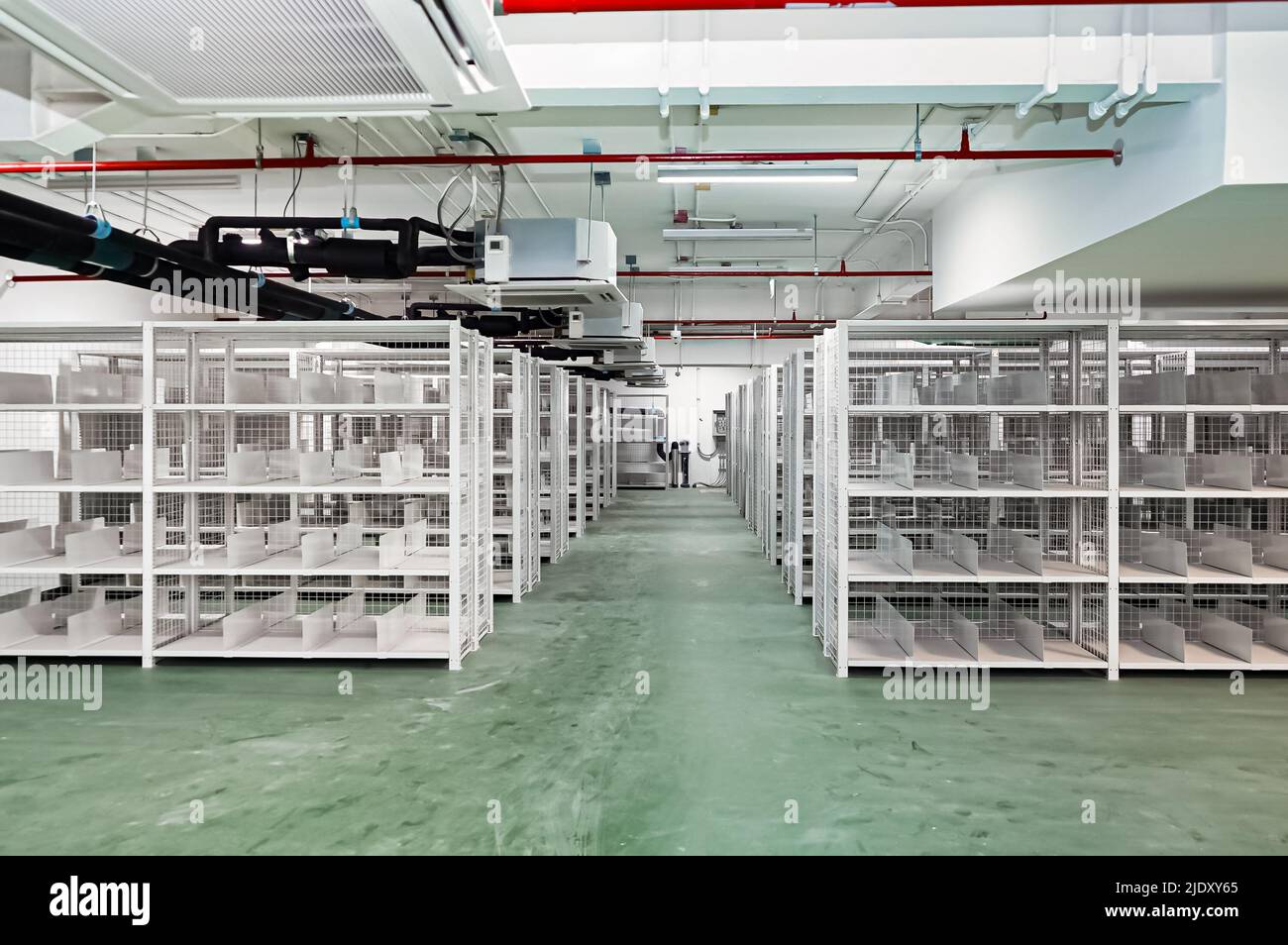 White shelves are lined up all over the area in a warehouse with a ...