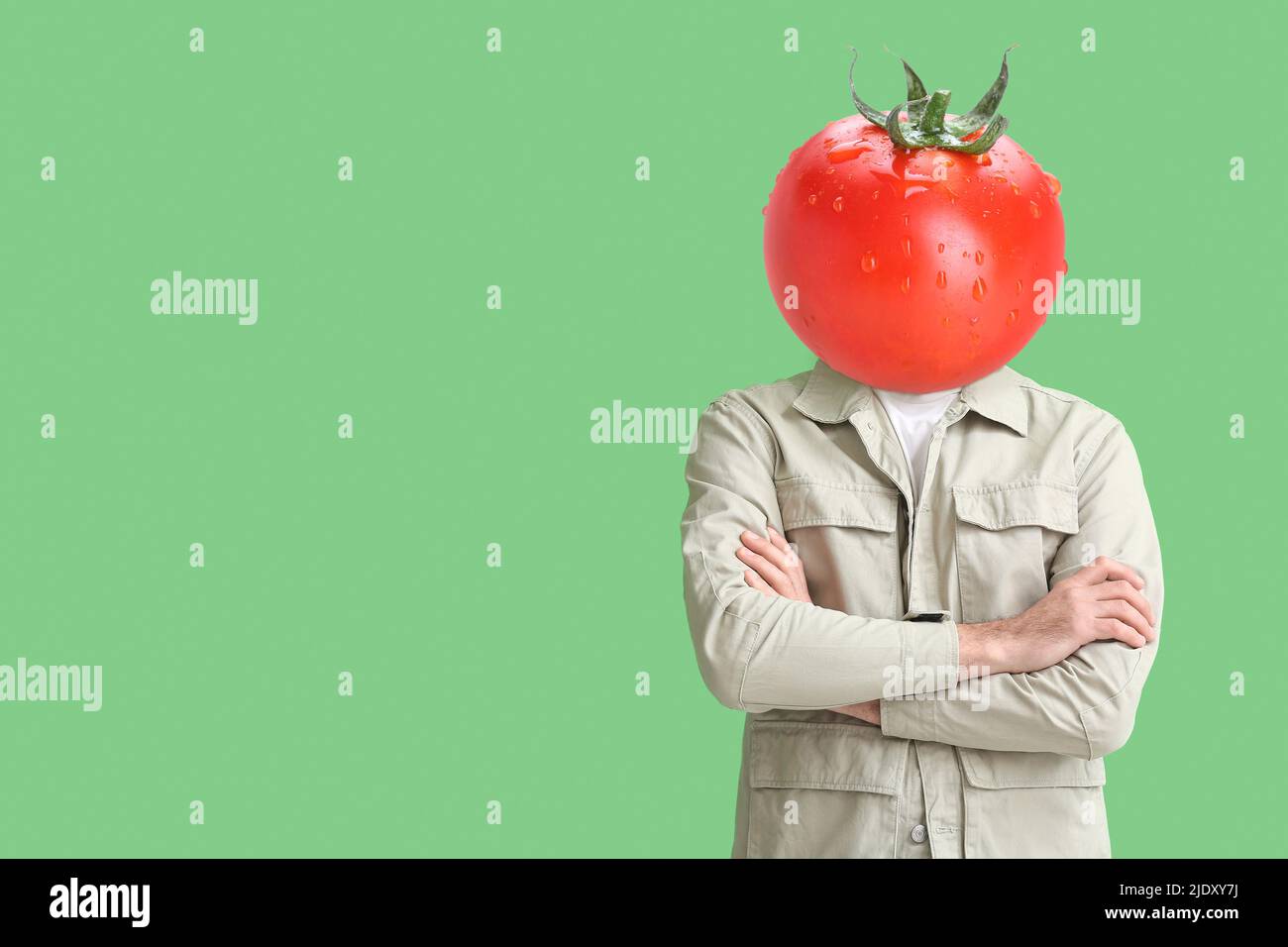 Man with fresh tomato instead of his head on green background Stock ...
