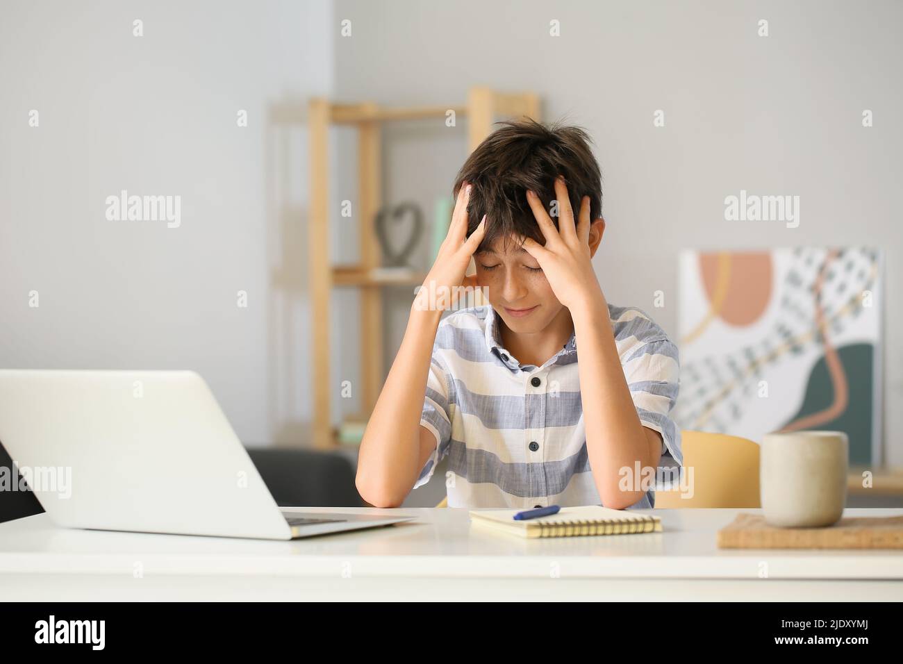 Stressed teenage boy learning at home Stock Photo - Alamy