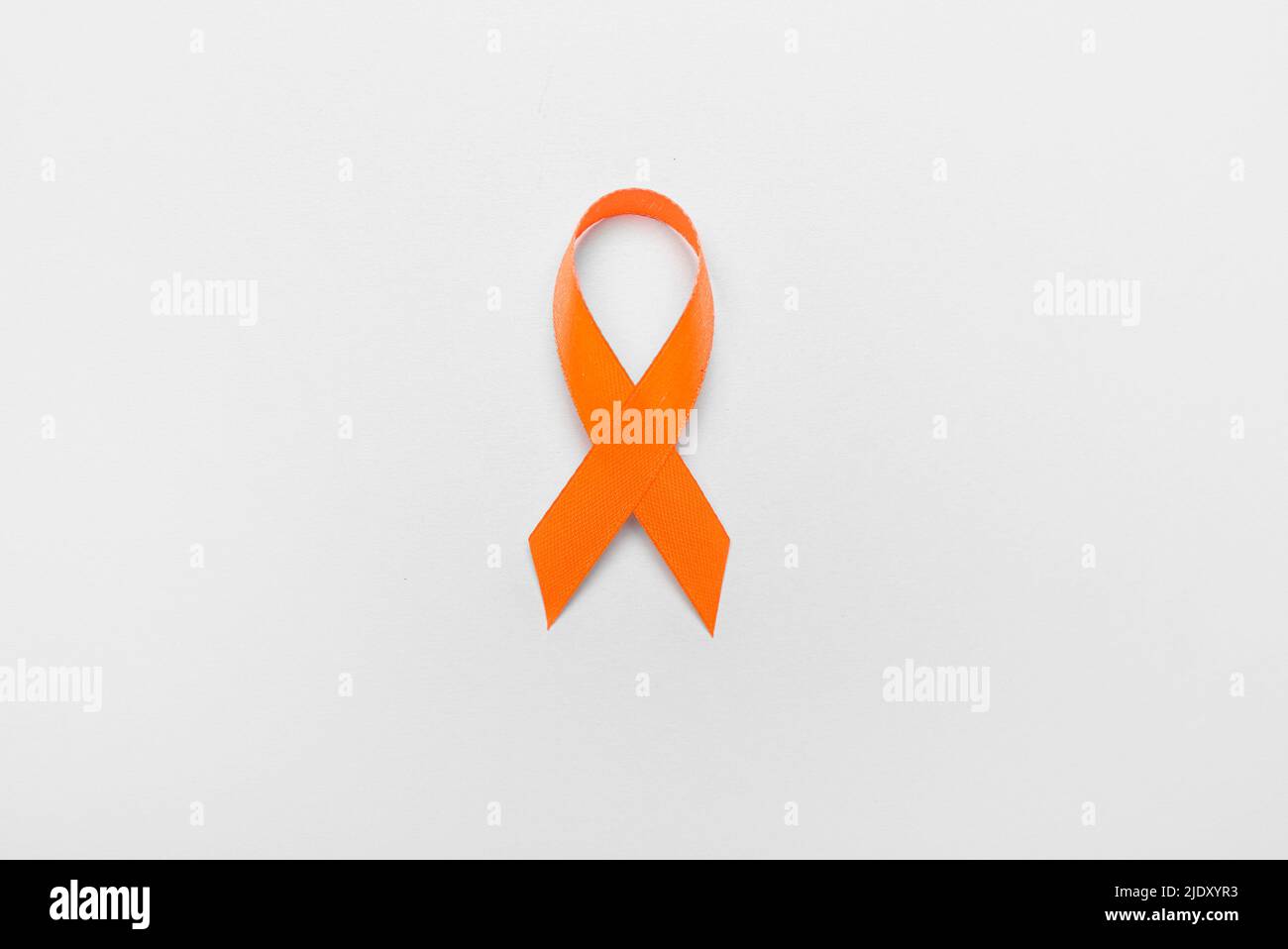 Orange awareness ribbon on grey background. Kidney cancer concept Stock ...