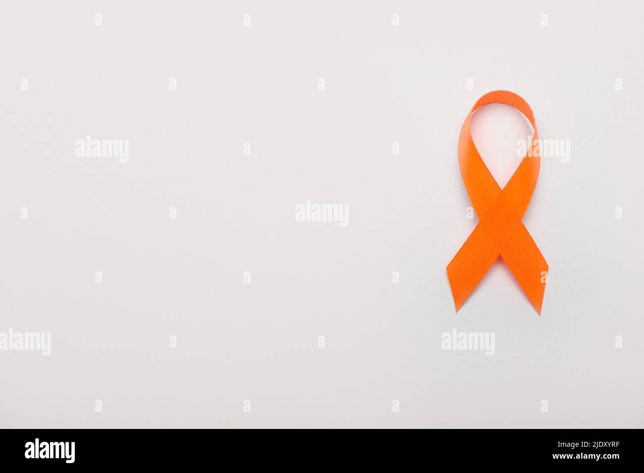 Orange awareness ribbon on grey background. Kidney cancer concept Stock ...