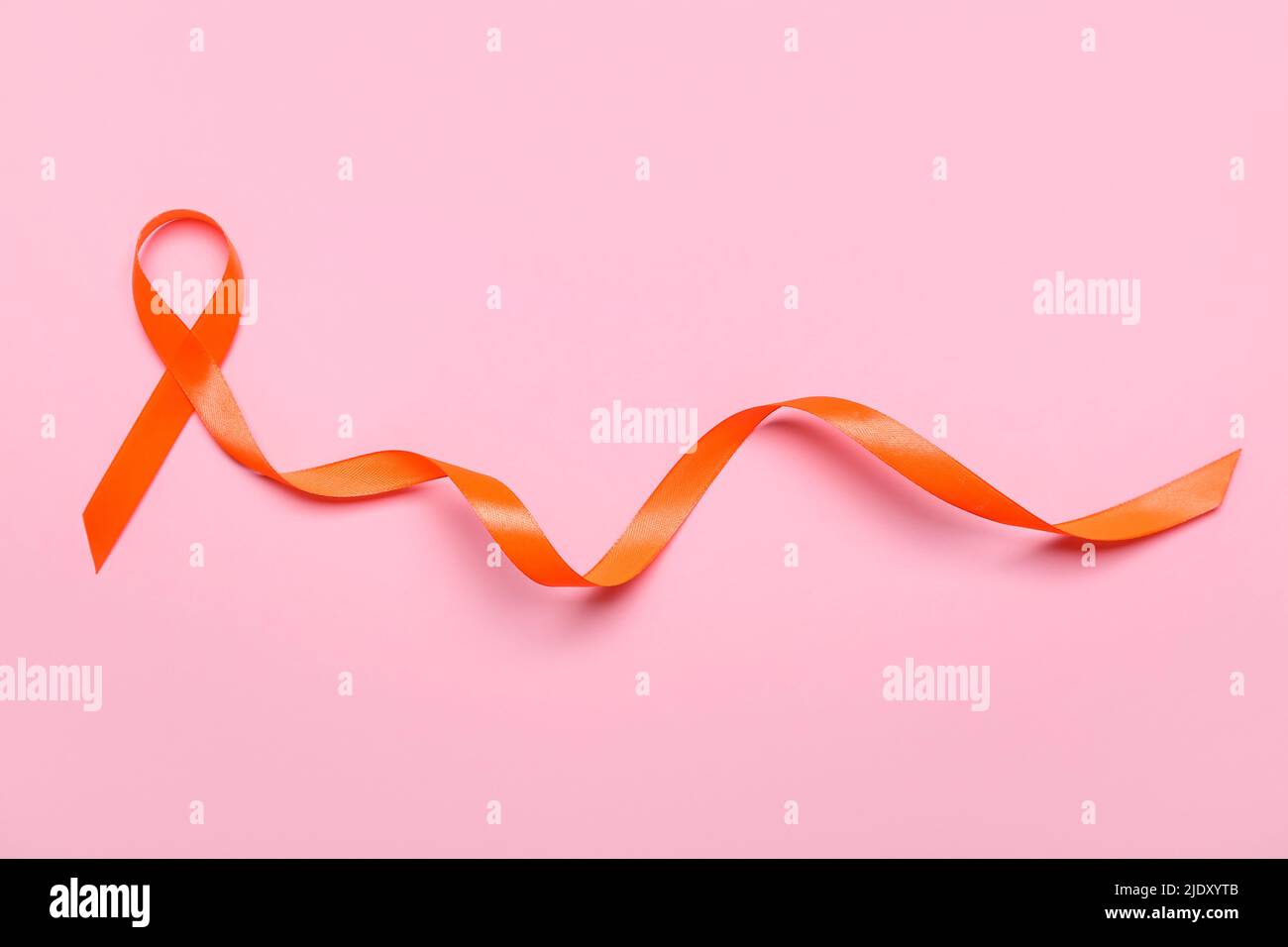 Orange awareness ribbon on pink background. Kidney cancer concept Stock ...