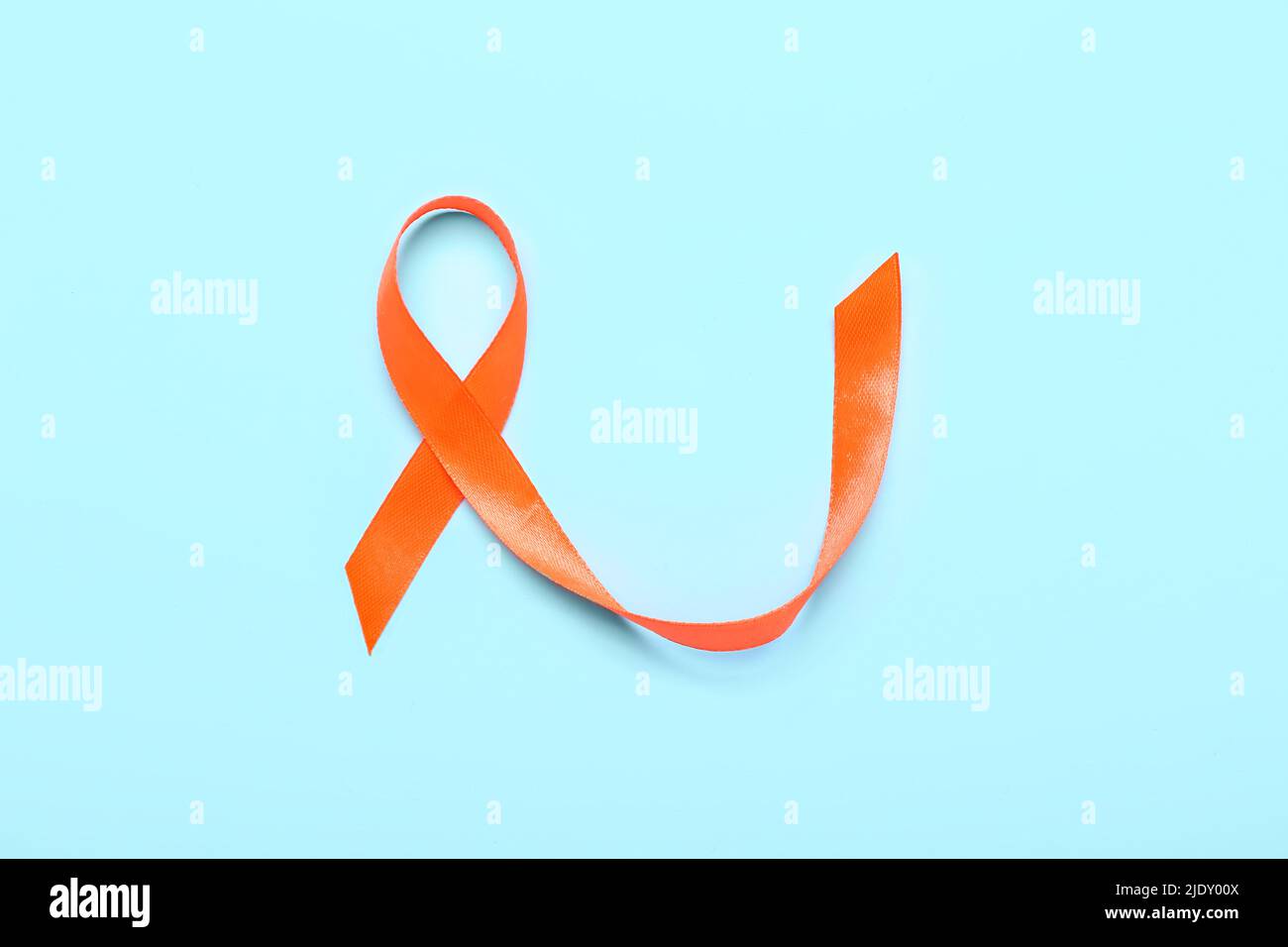 Orange awareness ribbon on blue background. Kidney cancer concept Stock ...