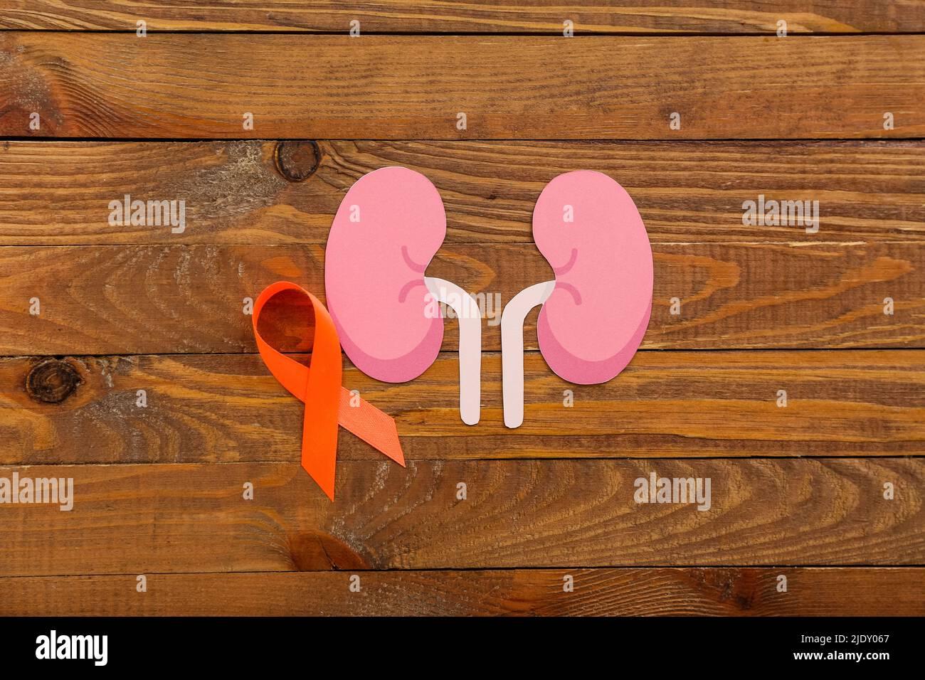 Orange awareness ribbon and paper kidneys on wooden background Stock ...