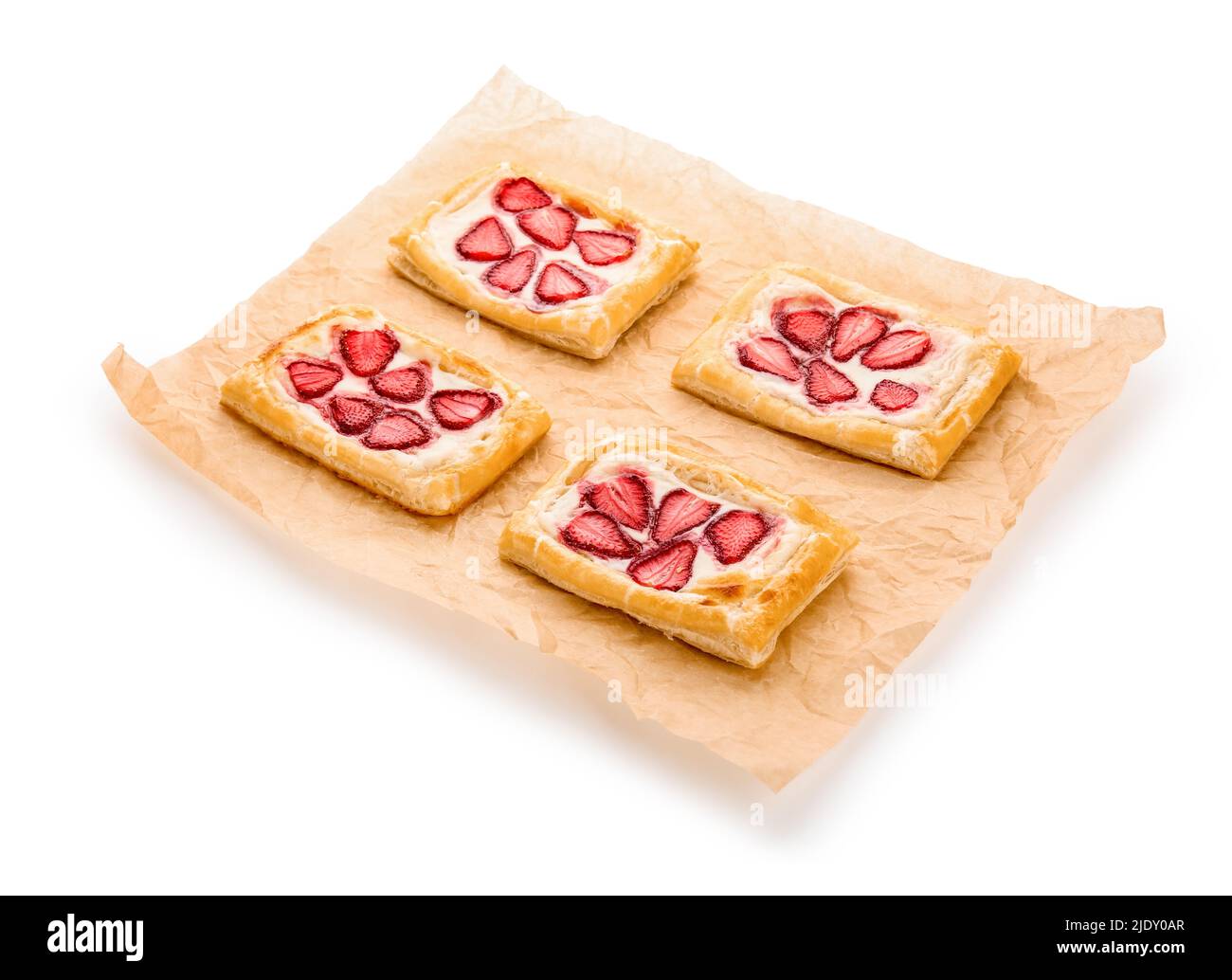 Parchment paper with strawberry puff pastries on white background Stock ...