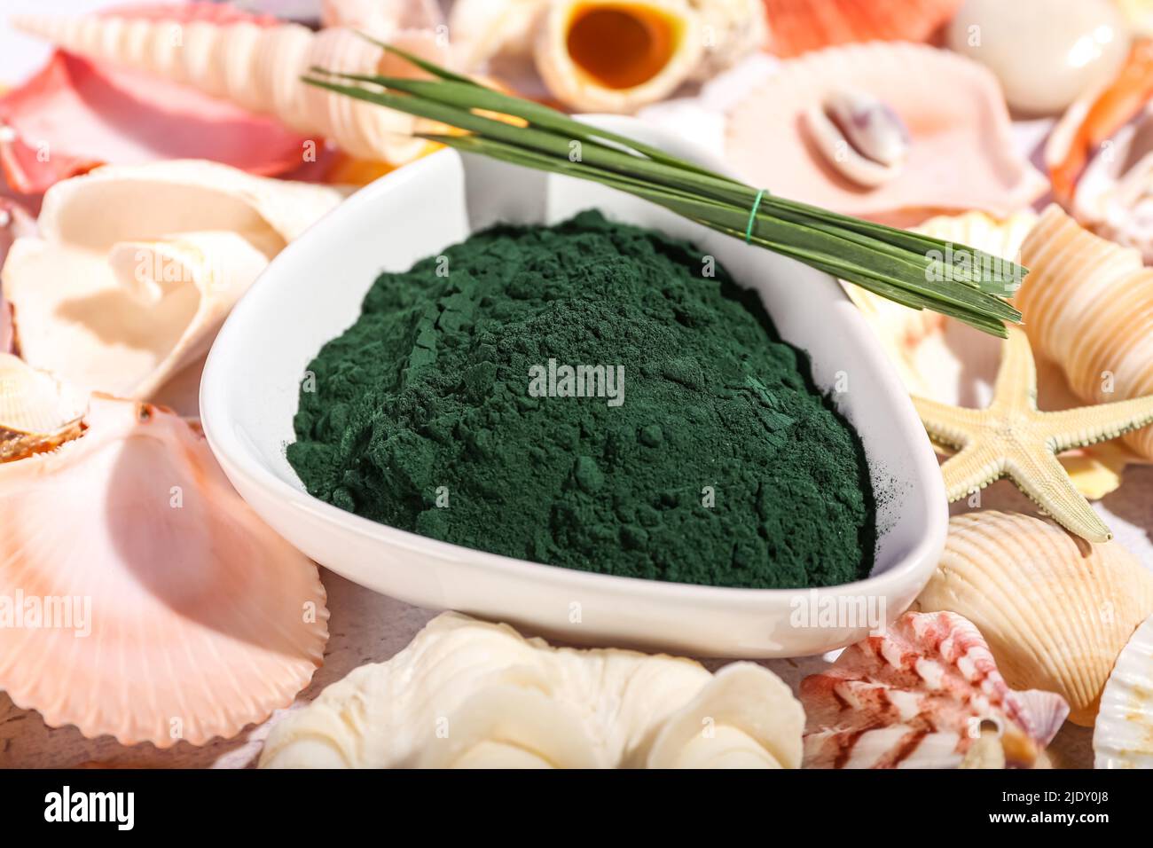 Bowl of spirulina powder and leaves on seashells Stock Photo - Alamy