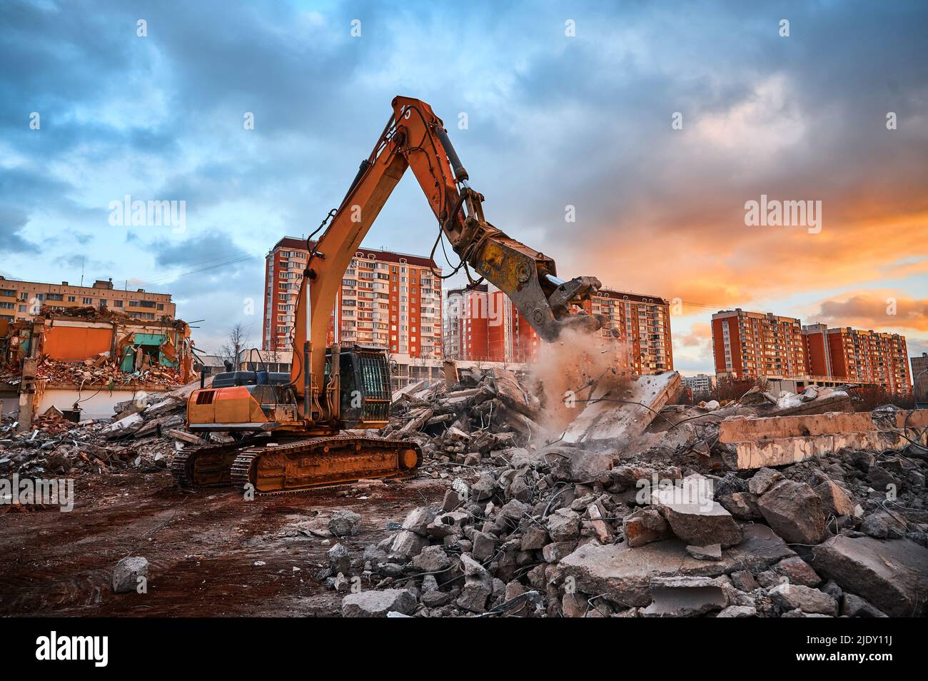 Excavator with concrete crusher on rig at demolition site Stock Photo ...