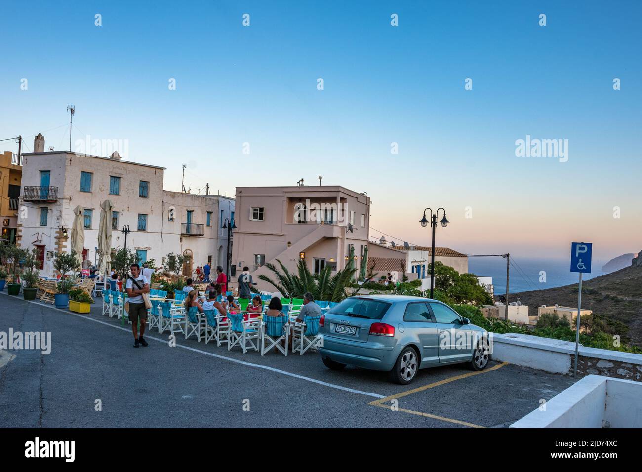 Architectural buildings with people walking by the the streets of Chora ...