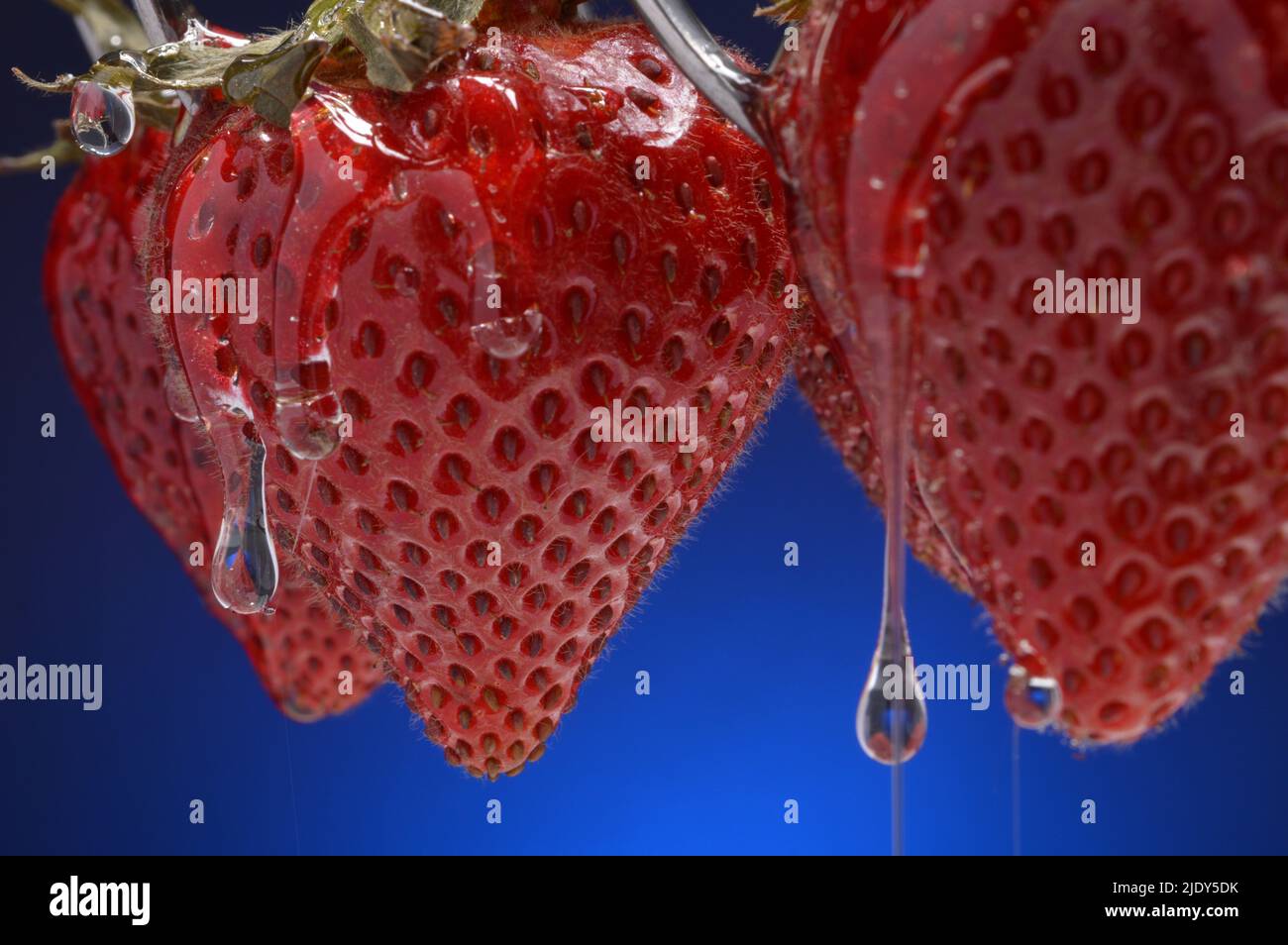 Strawberries dripping with sugary syrup Stock Photo - Alamy