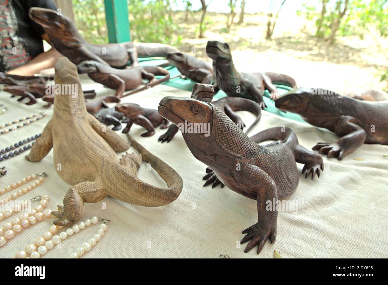 Wooden sculptures of komodo dragon at a souvenir stall in in Komodo ...