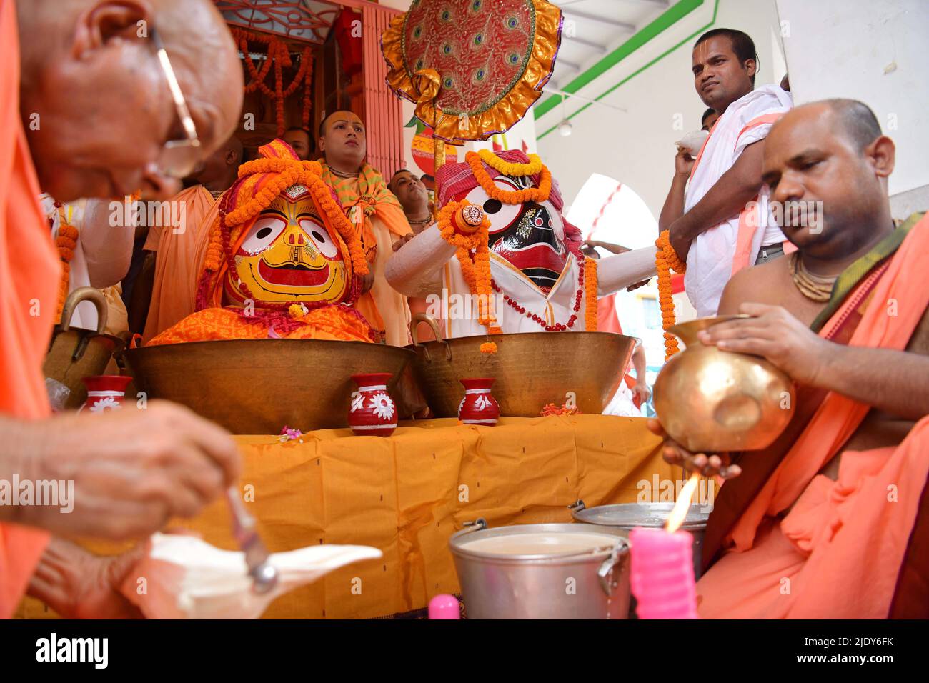 Hindu priests pour milk on top of deities Lord Jagannath, Balabhadra ...