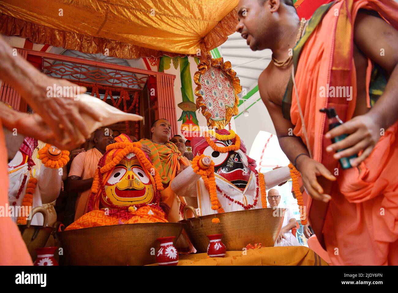 Hindu priests pour milk on top of deities Lord Jagannath, Balabhadra ...